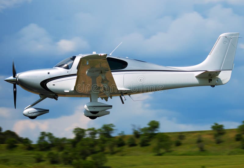 Aircraft Flying in Divergent Sunlight Stock Photo - Image of private ...
