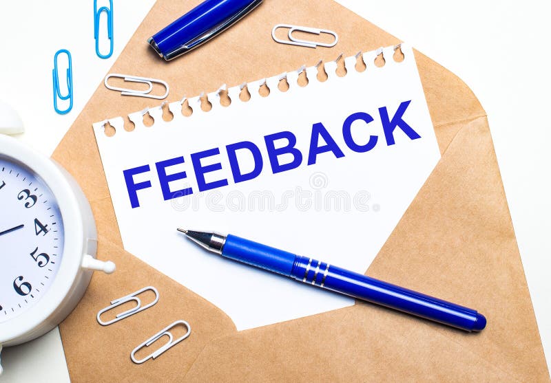 On a Light Background, a Craft Envelope, an Alarm Clock, Paper Clips, a ...