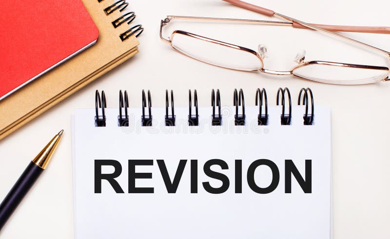 On a Light Background - Glasses in Gold Frames, a Pen, Brown and Red ...