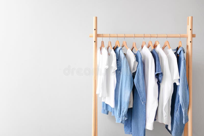 Rack with Hanging Clothes on Color Background Stock Image - Image of ...