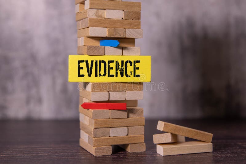 On a Light Background, Wooden Blocks with the Text EVIDENCE. Close-up ...