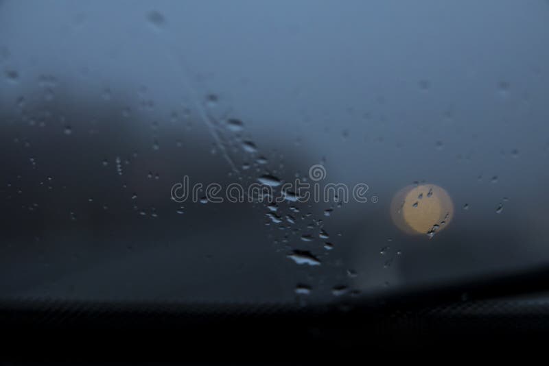 Light Beam and Rain Drops Reflected on the Car Window in Rainy Weather ...