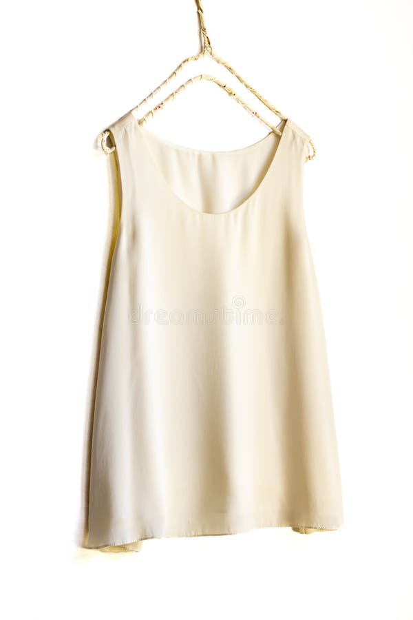 Light Beige or White Tank Top Hanging on a Hanger in a White Wall Stock ...