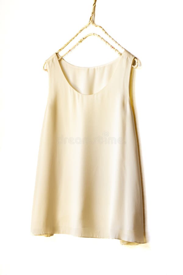 Light Beige or White Tank Top Hanging on a Hanger in a White Wall Stock ...