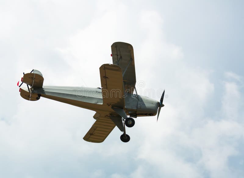 Biplane flying in sky stock photo. Image of displays - 208580974