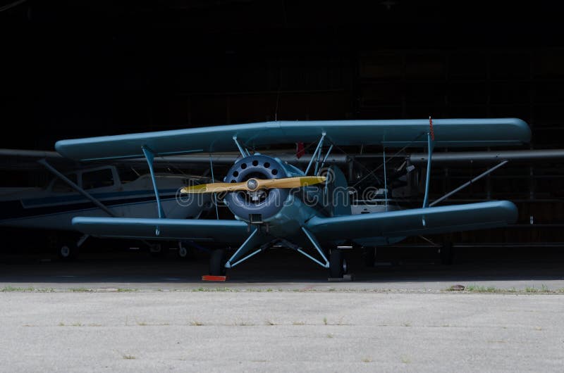 Light Blue Bi-Plane at the Opening To a Hangar Stock Image - Image of ...