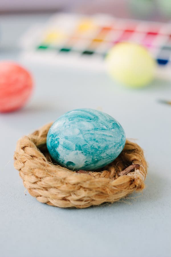 Light Blue Color Easter Egg on Nest Over Bright Background. Stock Image ...