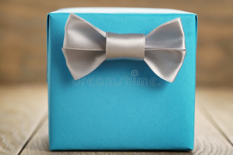 Light Blue Gift Box with Minimalistic Silver Ribbon Bow on Wooden Stock ...