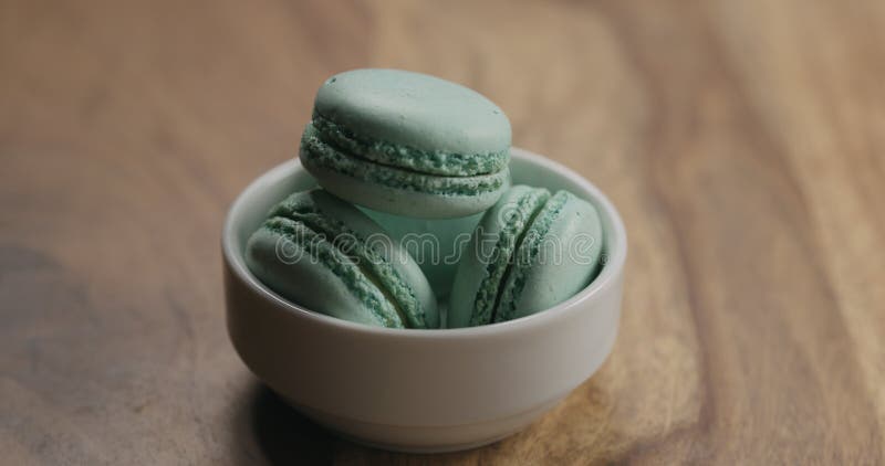 Light Blue Macarons in White Bowl on Wood Table Stock Photo - Image of ...