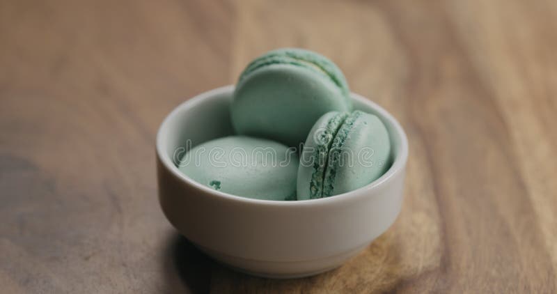 Light Blue Macarons in White Bowl on Wood Table Stock Image - Image of ...