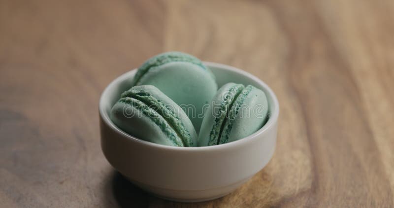 Light Blue Macarons in White Bowl on Wood Table Stock Photo - Image of ...
