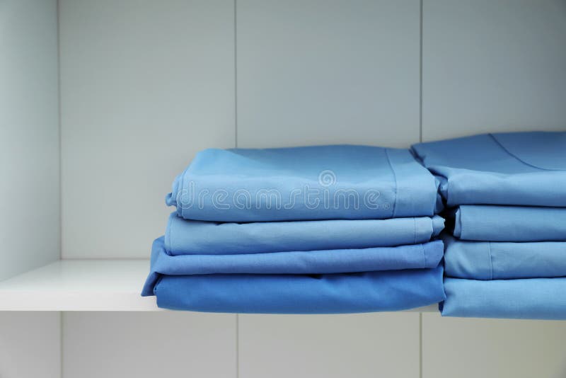 Light Blue Medical Uniforms on White Rack Stock Image - Image of ...