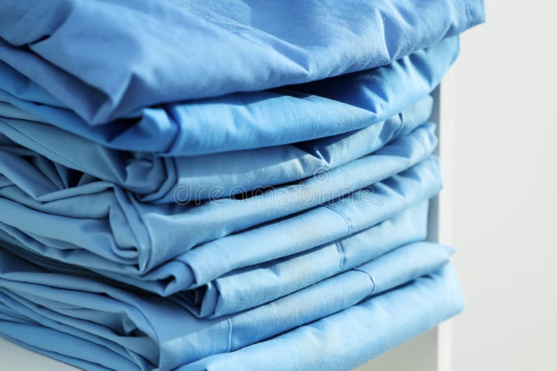 Light Blue Medical Uniforms on White Rack, Closeup Stock Photo - Image ...