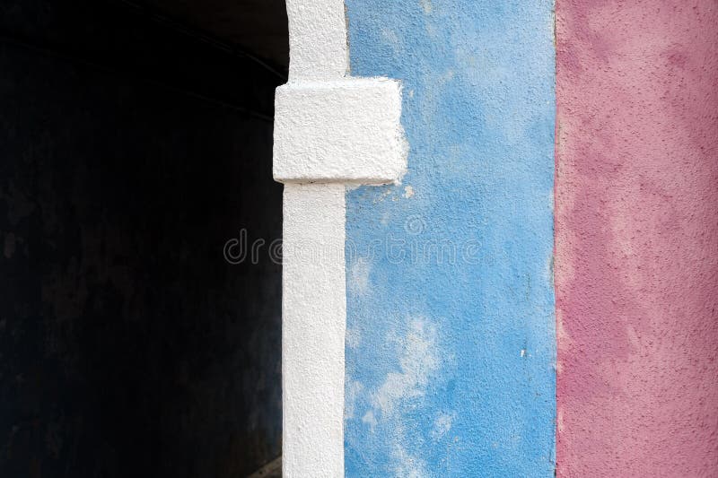 Light Blue and Pink Wall Next To White Arch and Dark Passageway Stock ...
