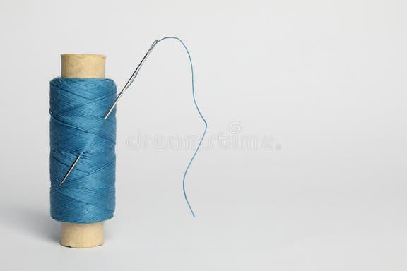 Light Blue Sewing Thread with Needle on White Background Stock Photo ...