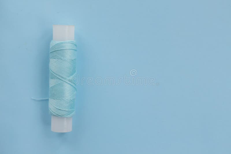 Light Blue Thread Mockup on Blue Background with Text Space. Sewing ...