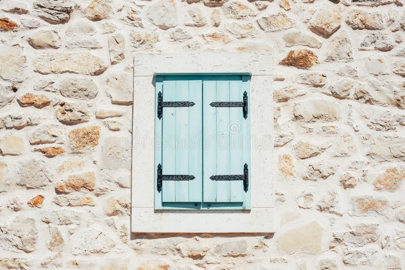 Light Blue Window Shutters Closed in a Stone Wall Stock Photo - Image ...