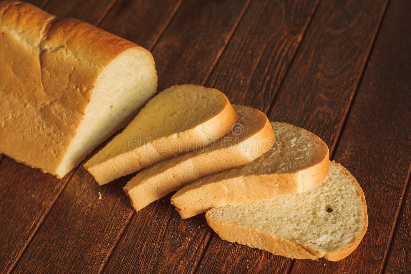Light Bread on Dark Wooden Background Stock Image - Image of slice ...