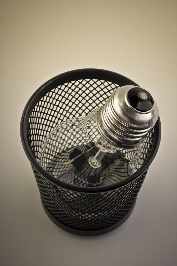Light bulb in trash bin stock image. Image of disposed - 1340121