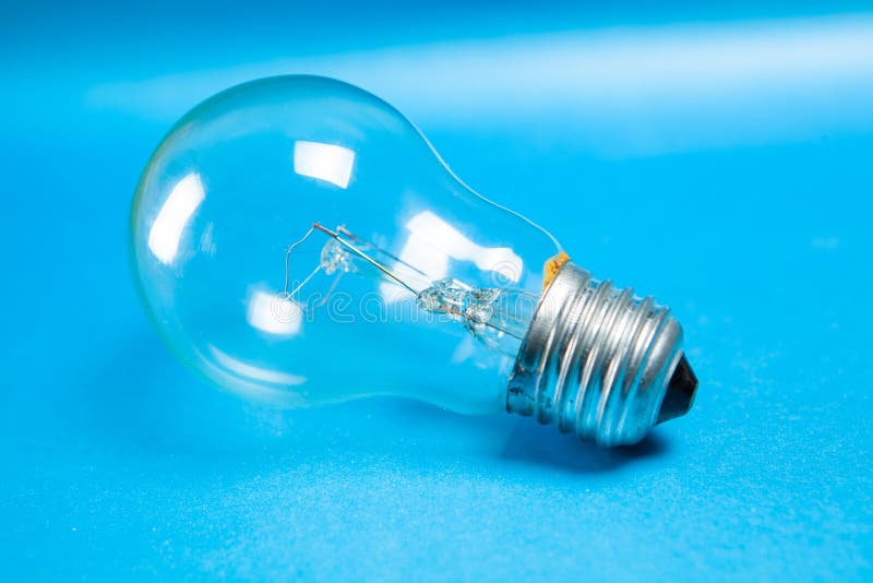 Light Bulb on Blue Background Stock Photo - Image of light, object ...