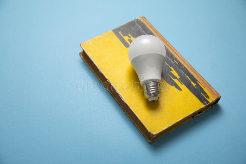 Light Bulb and Book on the Blue Background. Knowledge and Wisdom Stock ...