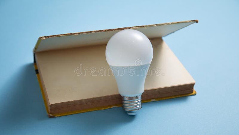 Light Bulb and Book on the Blue Background. Knowledge and Wisdom Stock ...