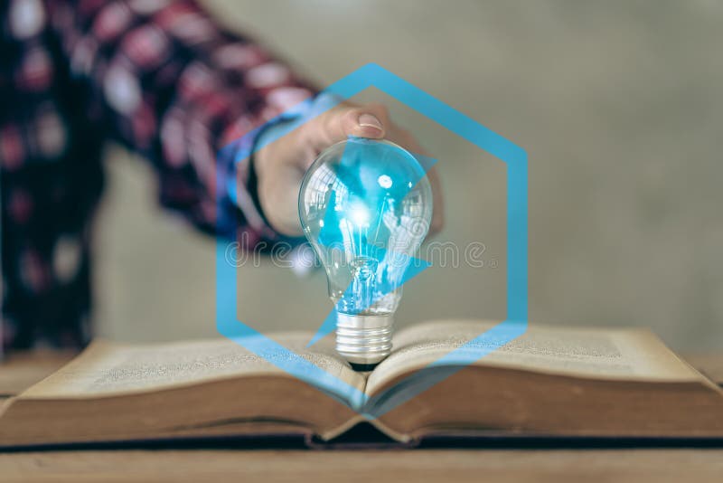 Light Bulb and Book on Wooden Table. and Inspiration and Learning with ...