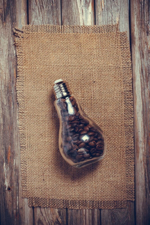 Light Bulb Bottle with Coffee Grains on Vintage Surface Stock Photo ...