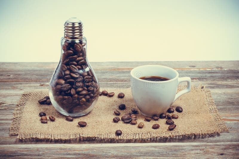 Light Bulb Bottle with Coffee Grains on Vintage Surface Stock Image ...