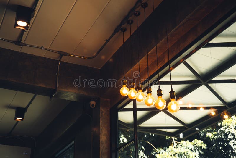 A Light Bulb in a Coffee Shop in Front of the Bar Stock Photo - Image ...