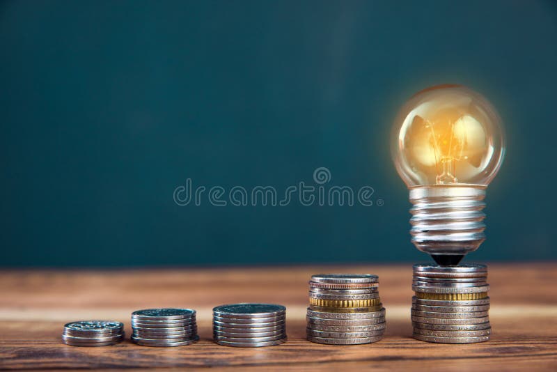 Light bulb on coins stock photo. Image of concept, economy - 196362148