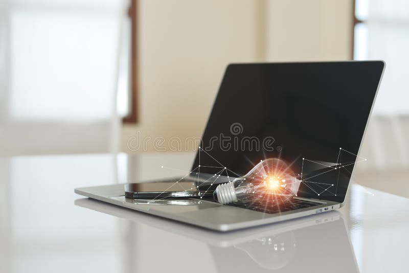 Light Bulb on Computer Laptop with Bright Light Flare. Think Creative ...