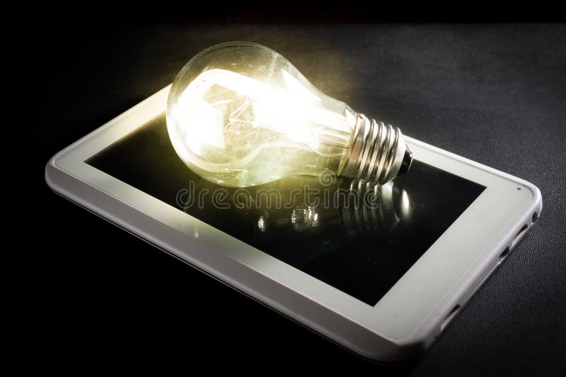 Light Bulb on Computer Tablet. Stock Photo - Image of information ...