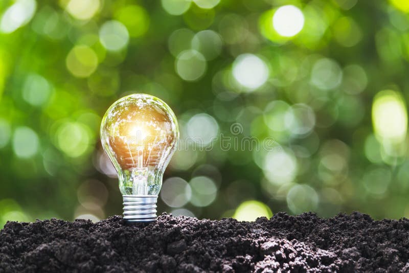 Light Bulb Concept Put on the Soil in Soft Green Nature Background ...