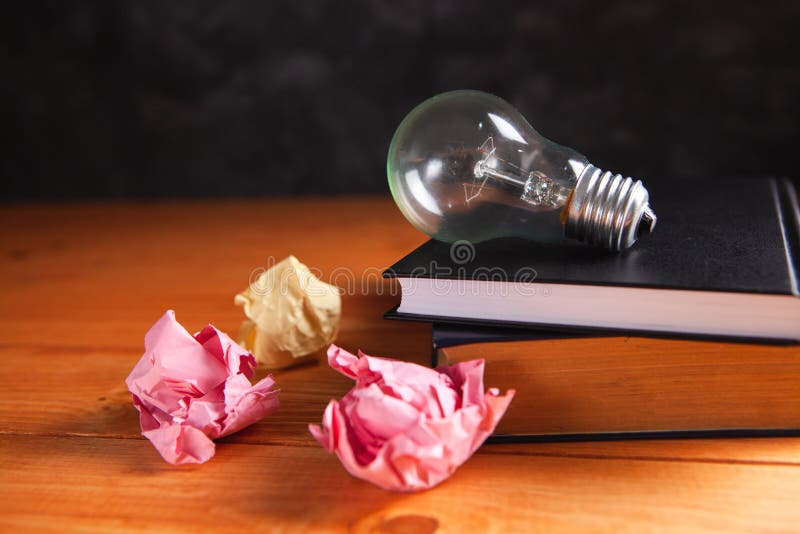 Light Bulb, Crumpled Papers and Notepad on the Table Stock Photo ...