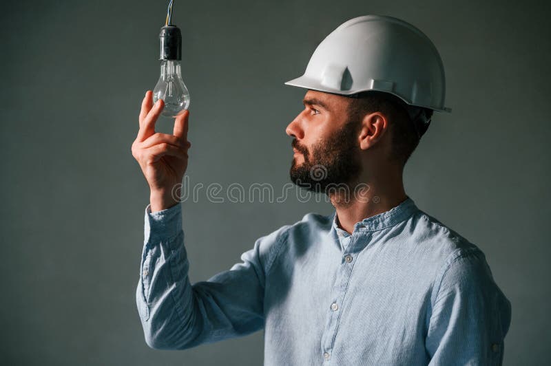 Light Bulb in the Dark Room. the Man is Making Repairs in the Apartment ...