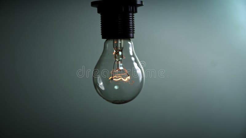 Light Bulb Flashes on a Blue Background in the Dark Stock Footage ...