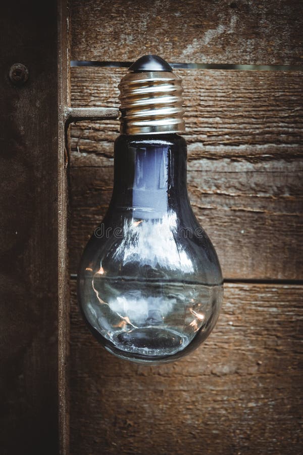 Light Bulb in Front of a Wooden Wall Stock Photo - Image of retro ...