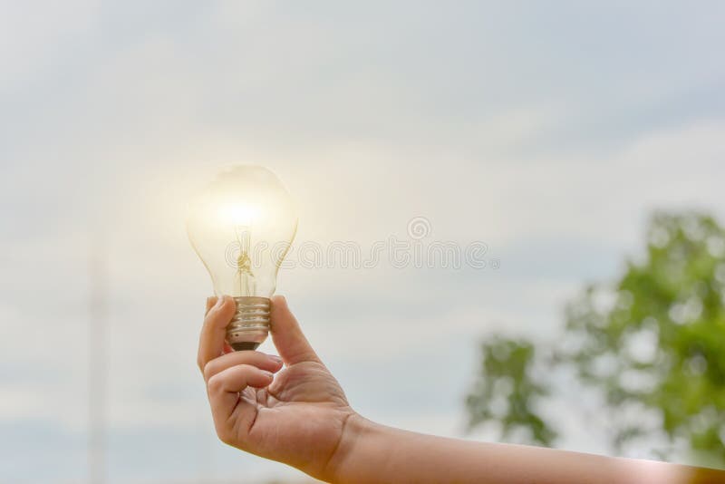 A Light Bulb Glows in the Hands of a Person Stock Photo - Image of male ...