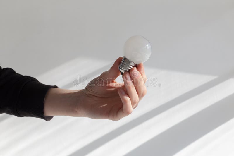 Energy Saving Light Bulb in Female Hand on White Background Stock Photo ...