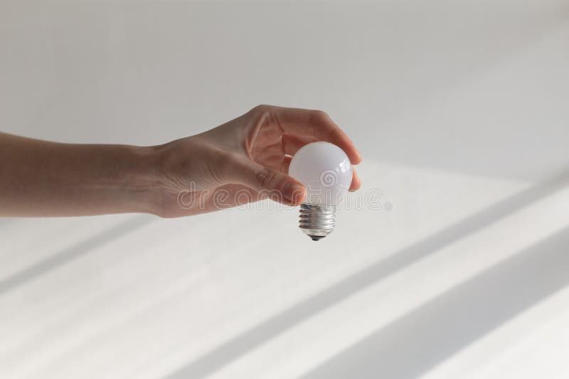 Energy Saving Light Bulb in Female Hand on White Background Stock Photo ...