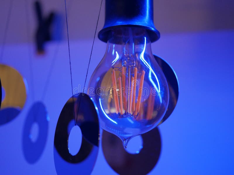 Light Bulb Hanging on the Background of Computer Hard Drive Disks in ...