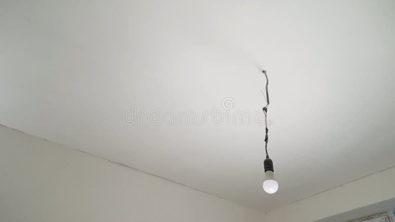 Light Bulb Hanging from Ceiling Showing Electrical Wiring during Home ...