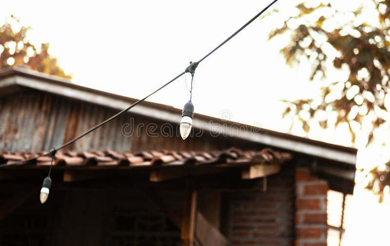 A Light Bulb Hanging from a Wire Stock Photo - Image of inspiration ...