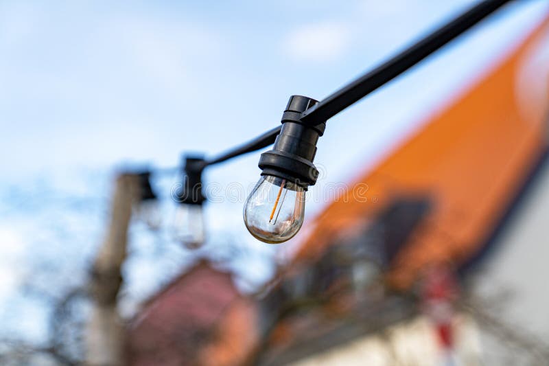 A Light Bulb is Hanging from a Wire Stock Photo - Image of electricity ...
