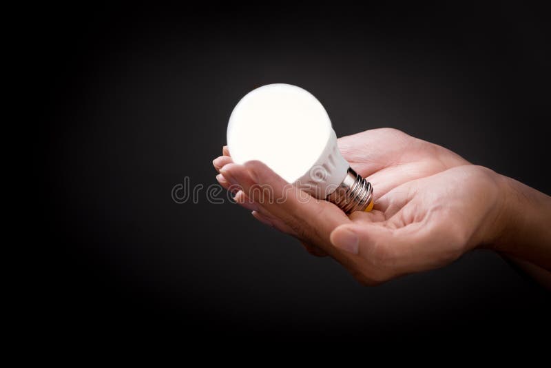 Light Bulb Hold in Hand on Black Background Stock Photo - Image of ...
