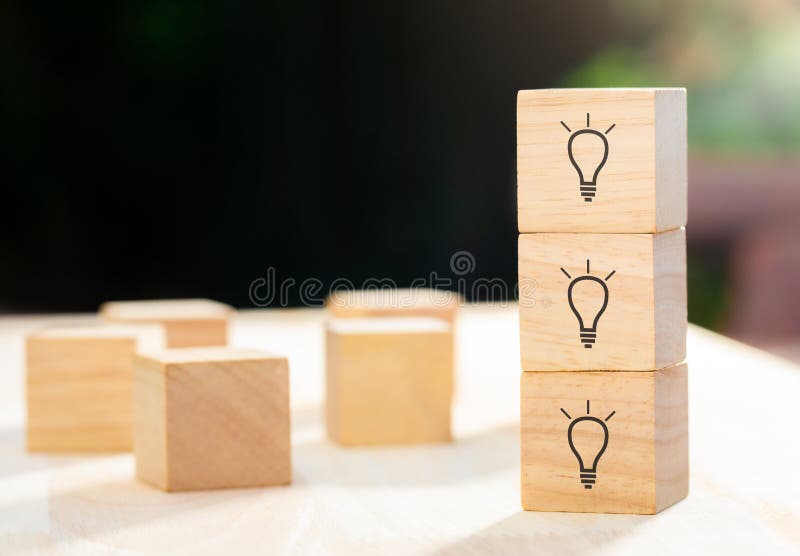 Light Bulb Icon on Wood Cube Stacking Stock Image - Image of green ...