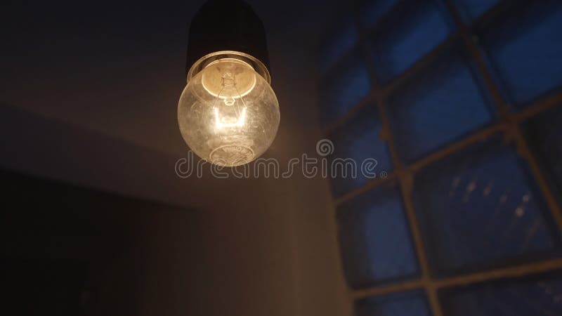 Light Bulb without Lamp Hanging from the Ceiling in the Dark. Stock ...