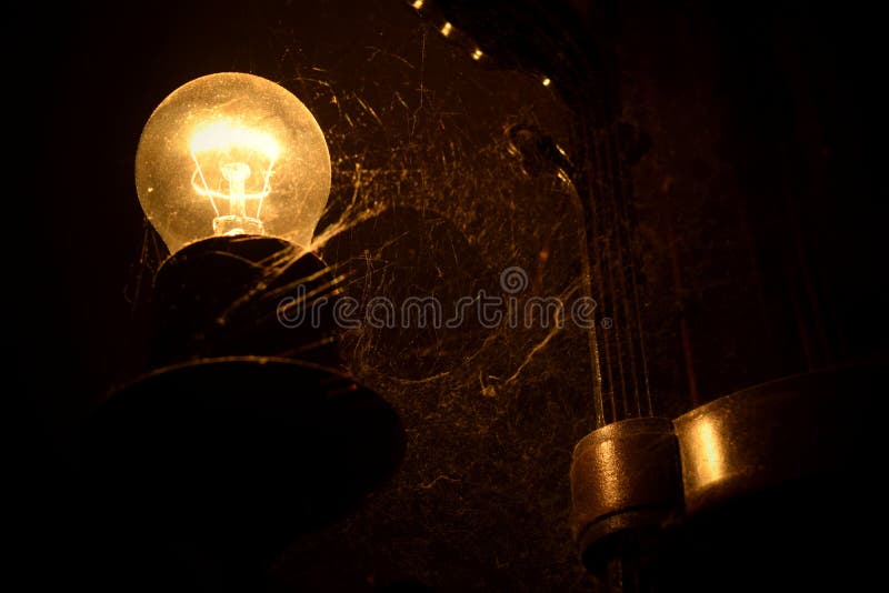Light Bulb in a Lamp with a Web Stock Image - Image of bulb, dark ...