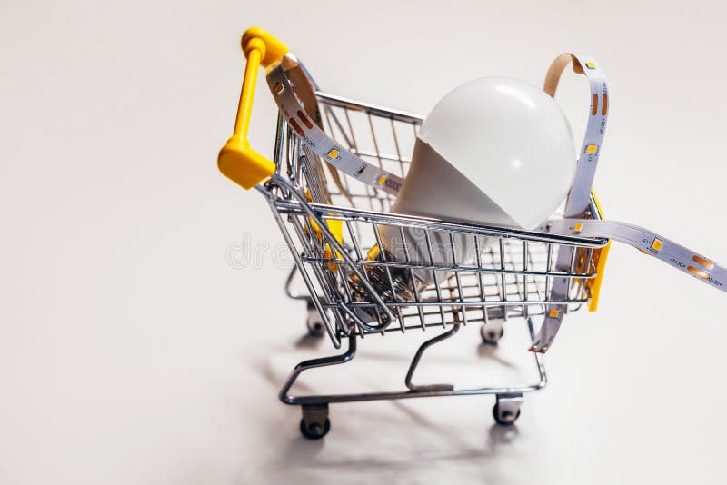 Light Bulb and Led Light Strip in Shopping Trolley. Saving Energy Stock ...